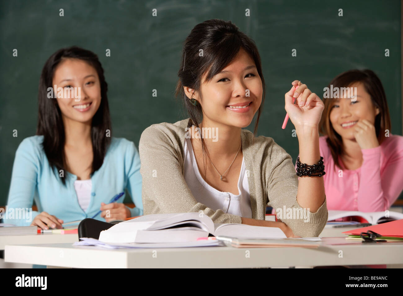 Three women in classroom Stock Photo - Alamy