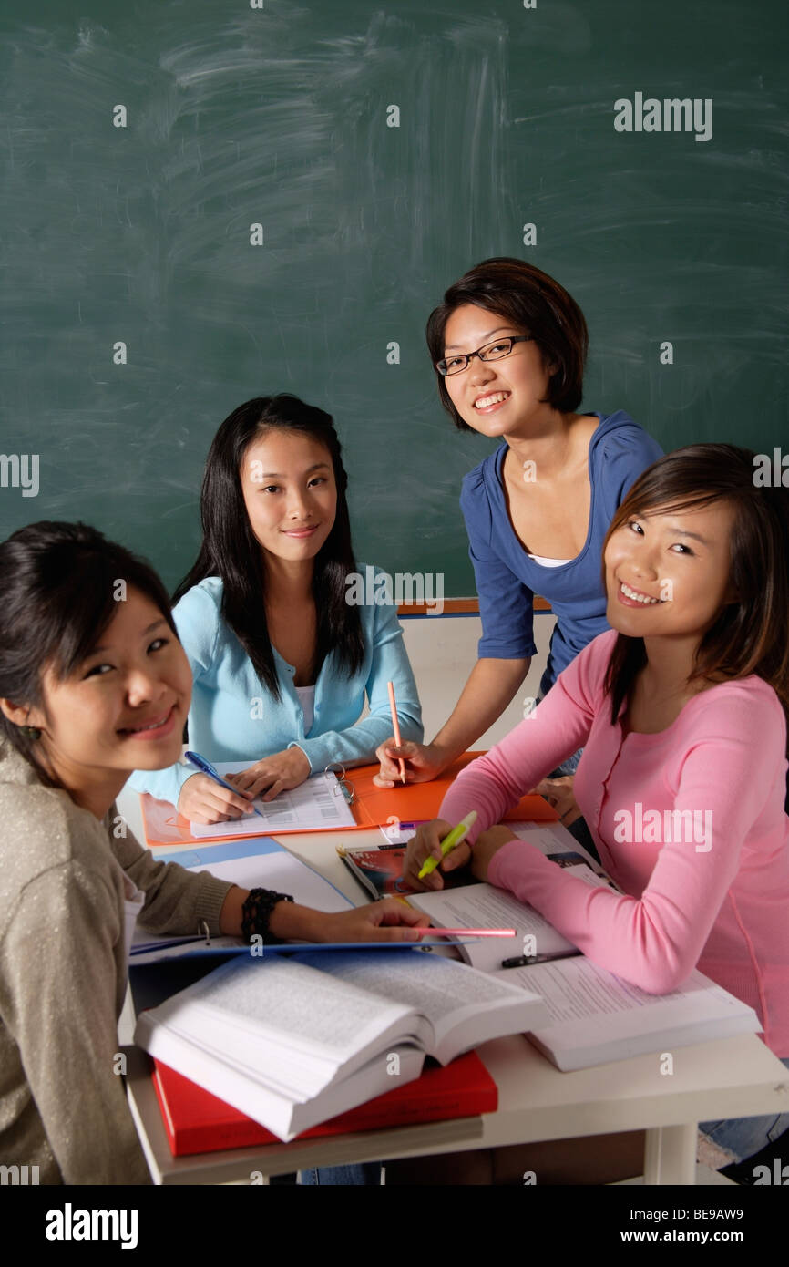 Four young women studying together Stock Photo - Alamy