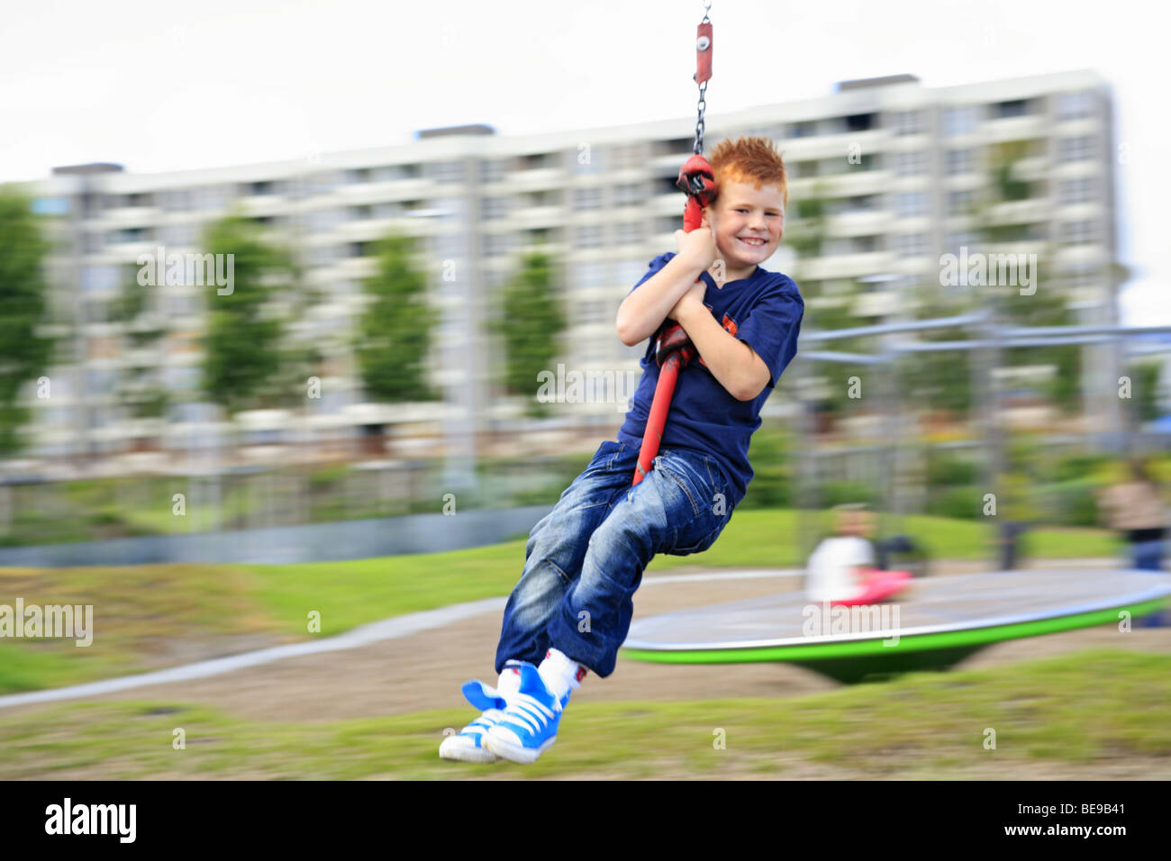 young boy on a zip line at a playground Stock Photo - Alamy