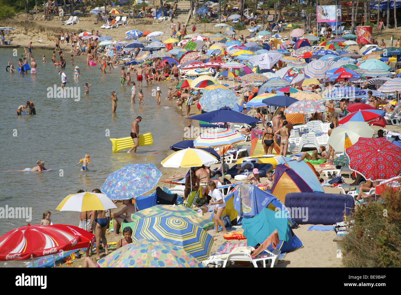 Croatia. Island Rab.Umbrelas on the beach. Crowded beach. Paradise ...