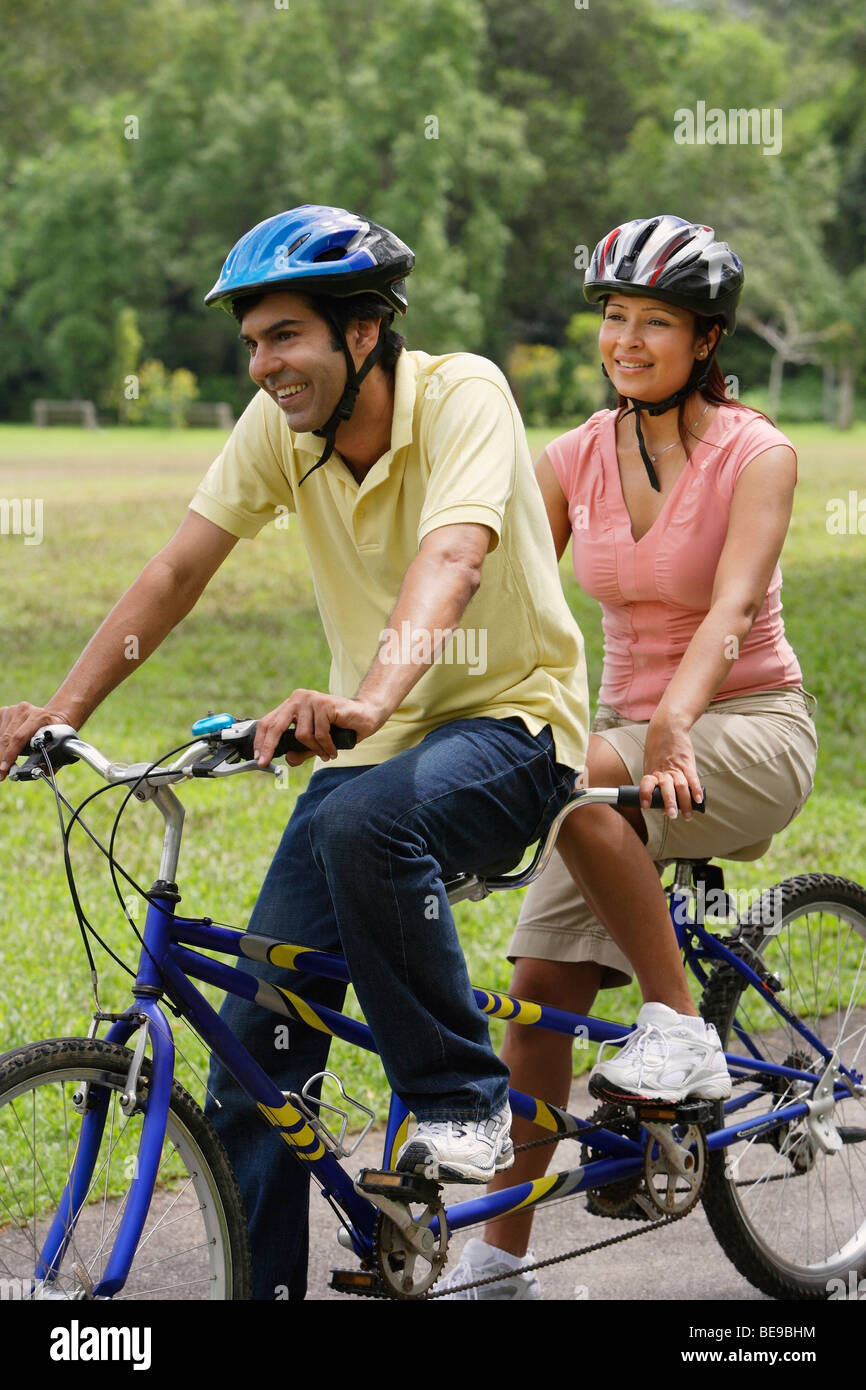 A couple ride a bike together Stock Photo - Alamy