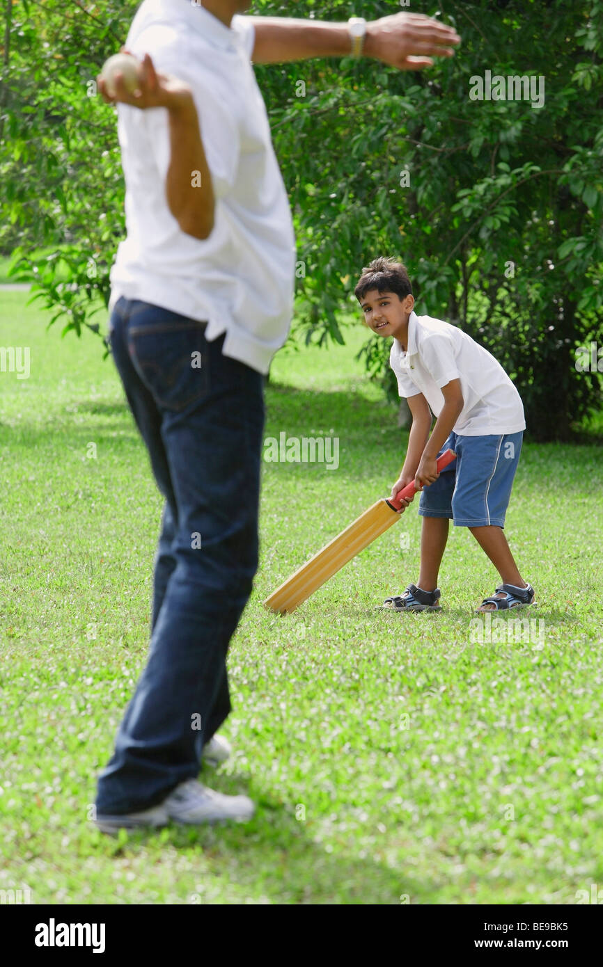 A father and son play cricket together Stock Photo - Alamy
