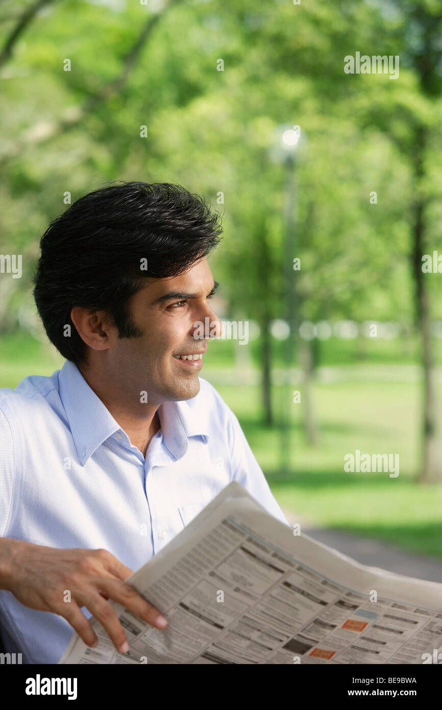 A man reads the newspaper in the park Stock Photo - Alamy