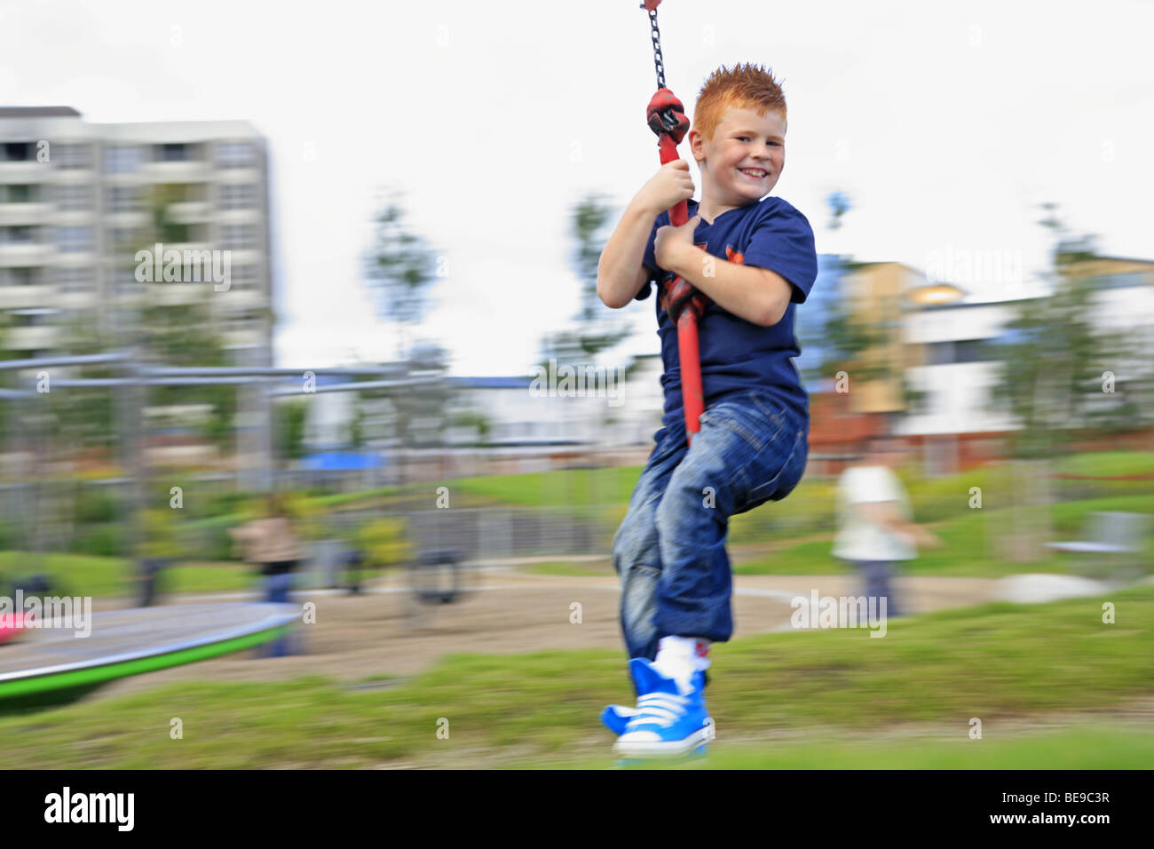 young boy on a zip line at a playground Stock Photo - Alamy
