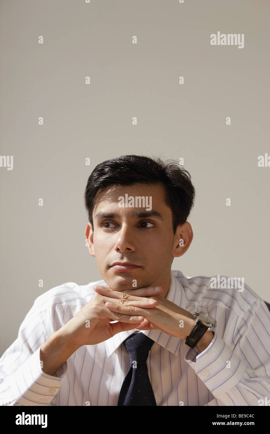 A man sits with his head resting on his hands Stock Photo - Alamy