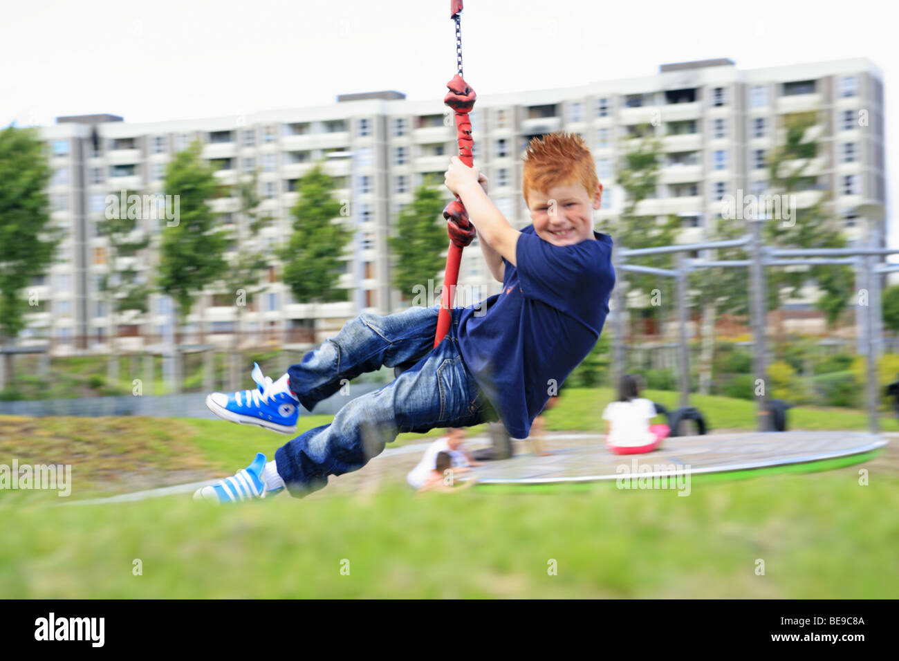 young boy on a zip line at a playground Stock Photo - Alamy