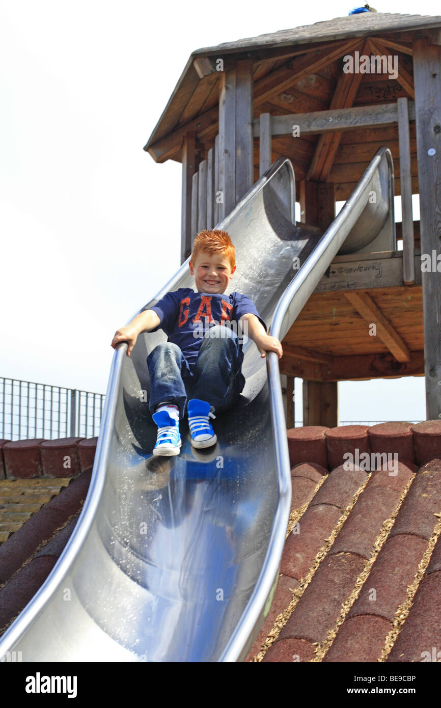 young boy on a slide at a playground Stock Photo - Alamy