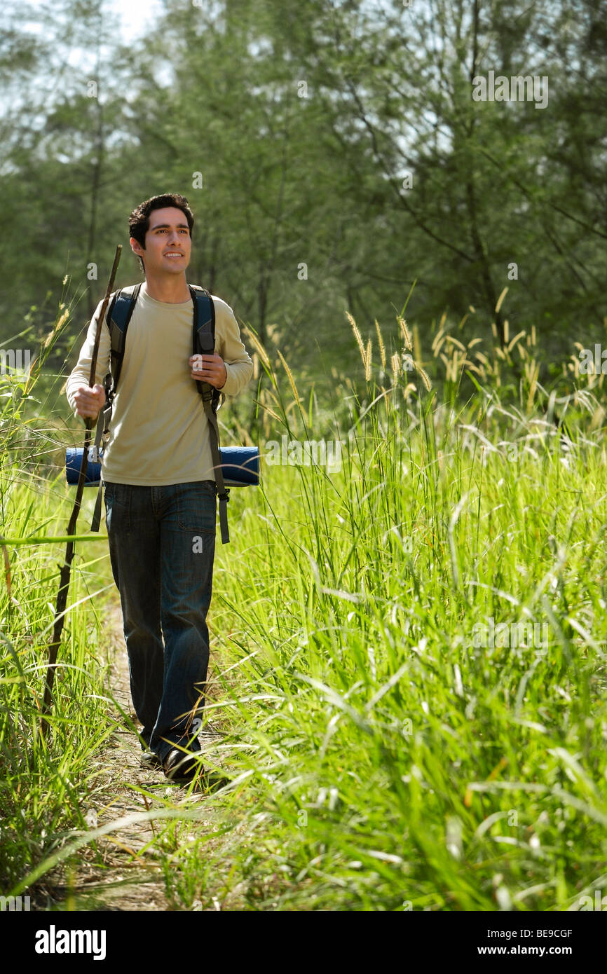 Young man hiking in the wilderness Stock Photo - Alamy