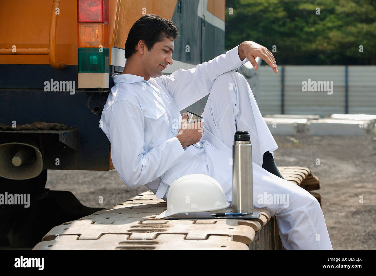 Man in work uniform taking a break Stock Photo - Alamy