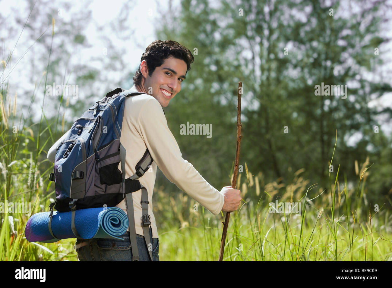 Young man hiking in the wilderness Stock Photo - Alamy