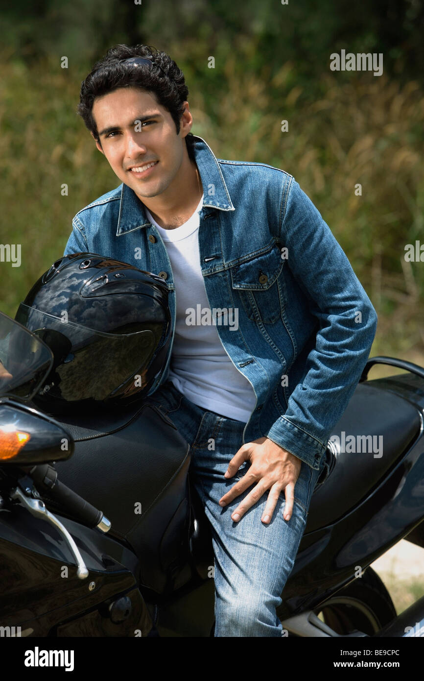 Young man riding motorbike Stock Photo - Alamy
