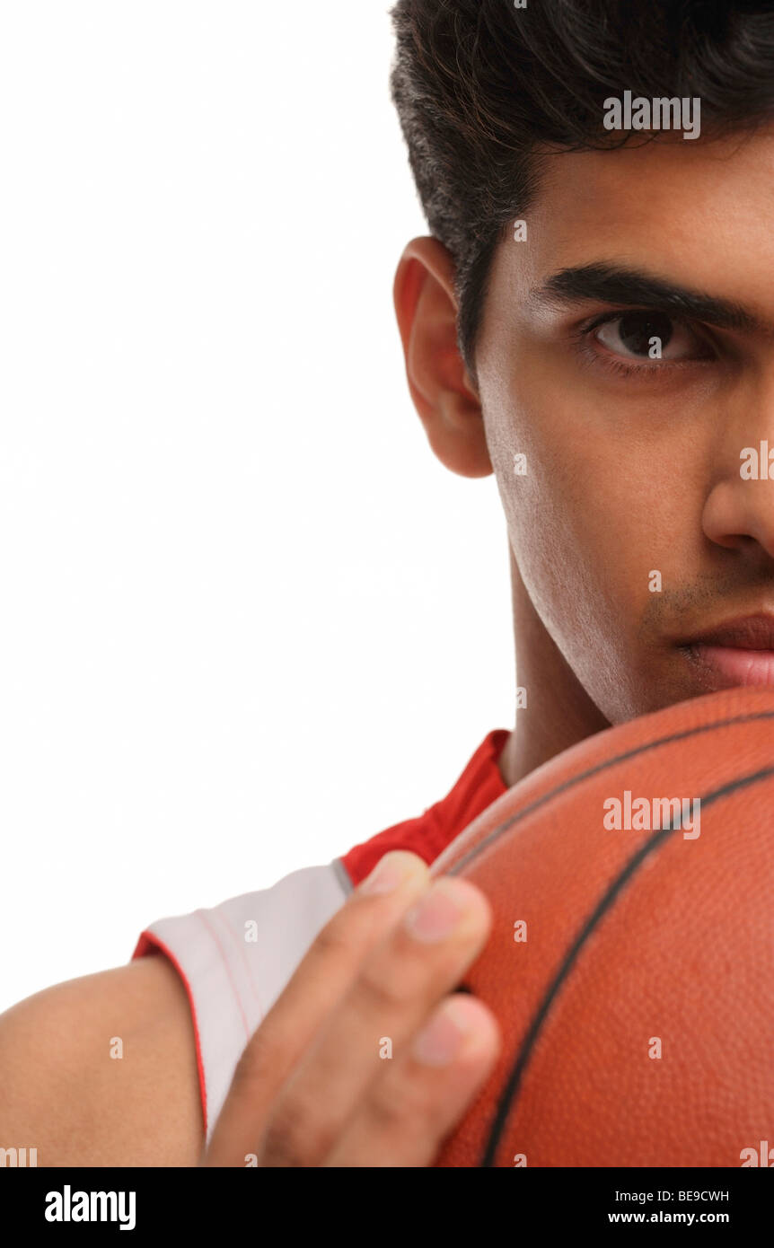 Young man with basketball looking at camera Stock Photo - Alamy