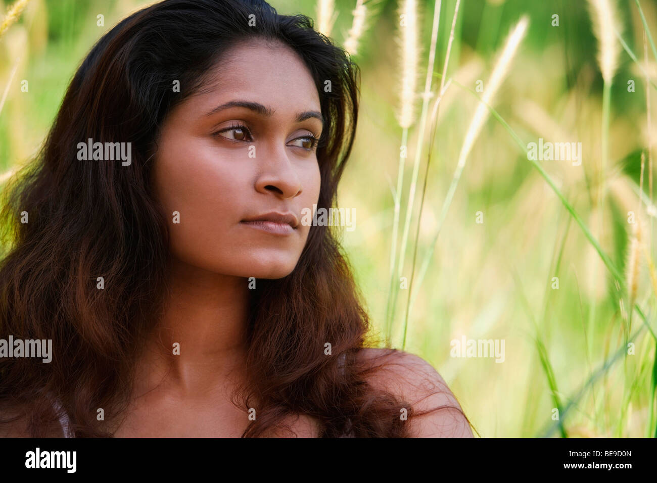 Young woman looking into distance Stock Photo - Alamy