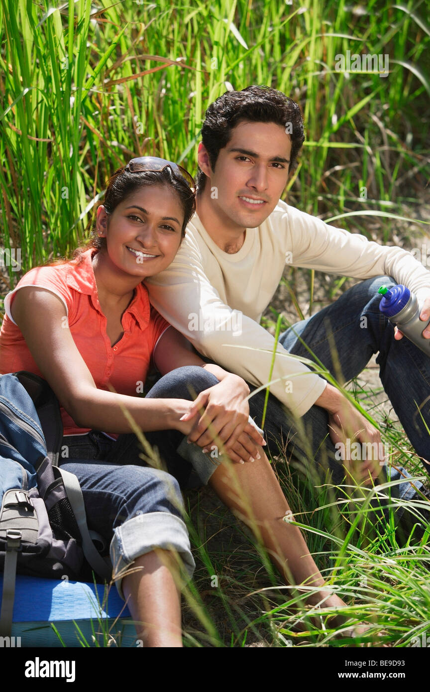 Young couple taking a break, smiling at camera Stock Photo - Alamy