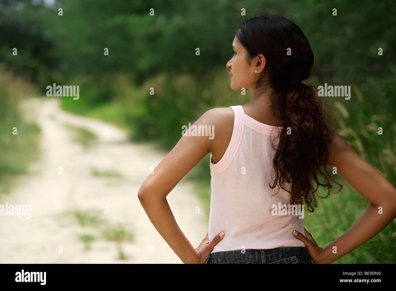 Young woman looking into distance Stock Photo - Alamy