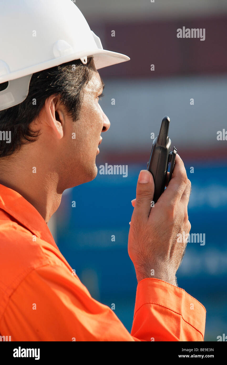 Man in work uniform using walkie talkie Stock Photo - Alamy