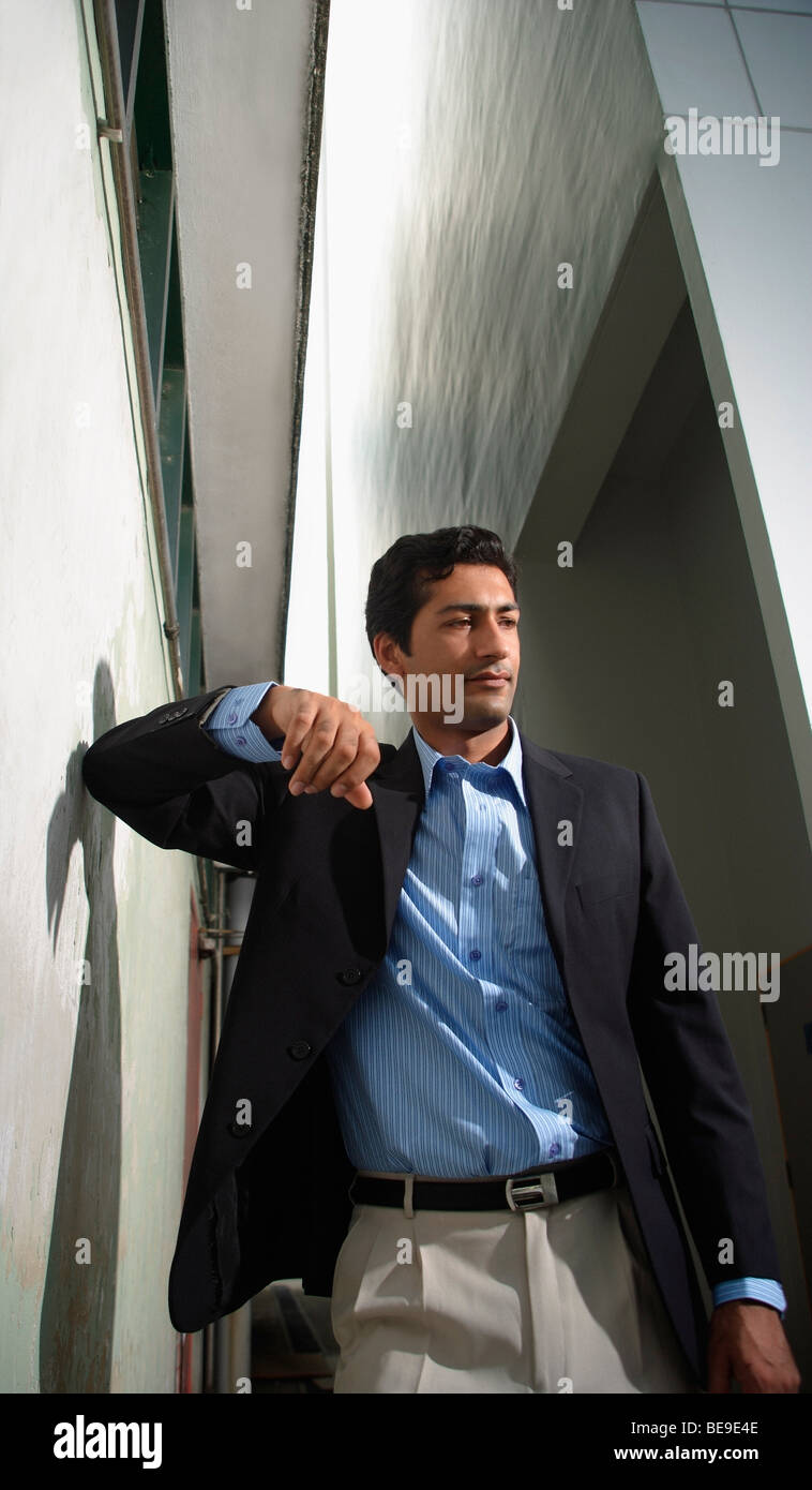Man leaning against wall Stock Photo - Alamy