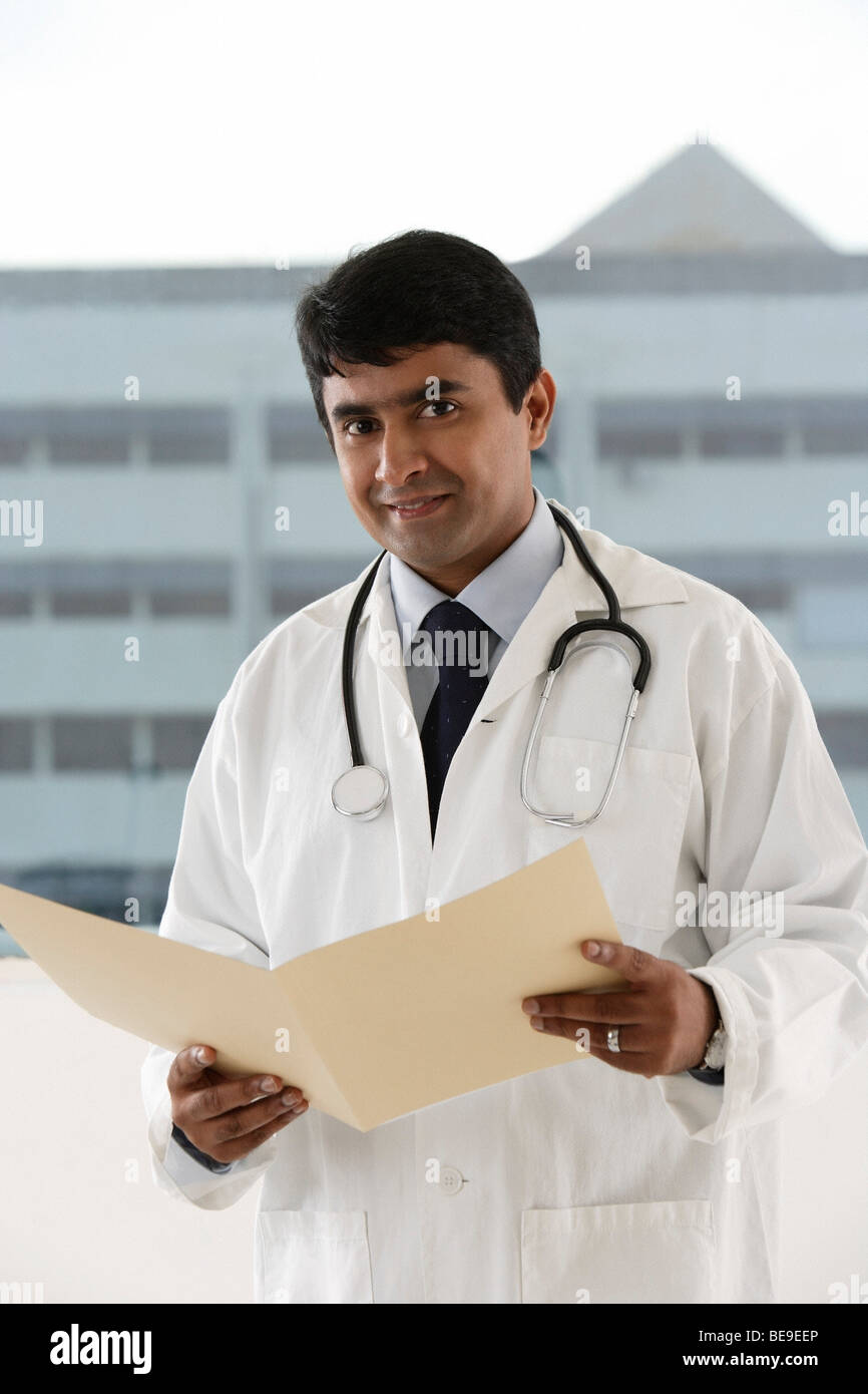 doctor holding patient file Stock Photo - Alamy