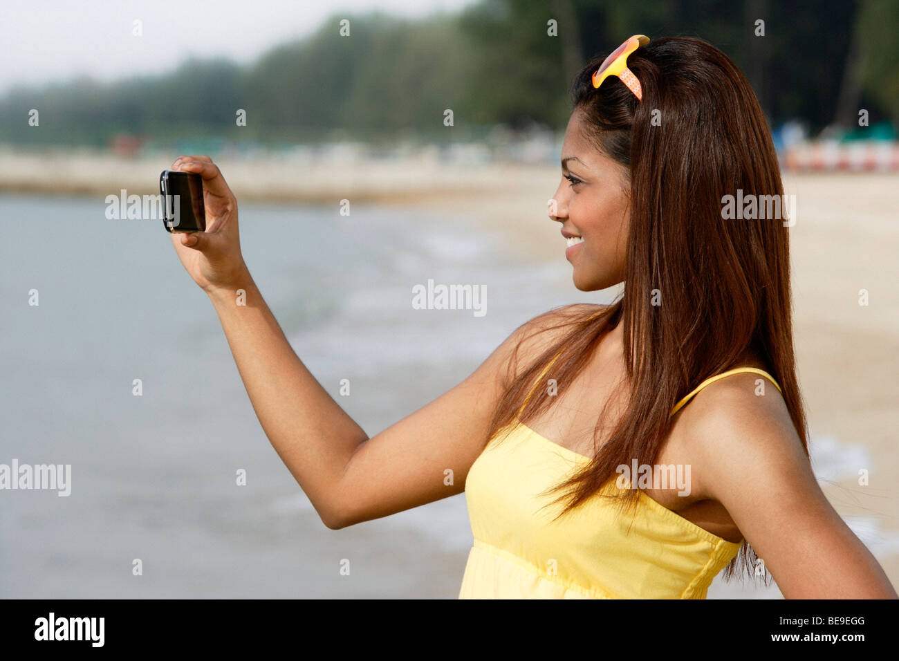 Side view of woman taking a picture Stock Photo - Alamy