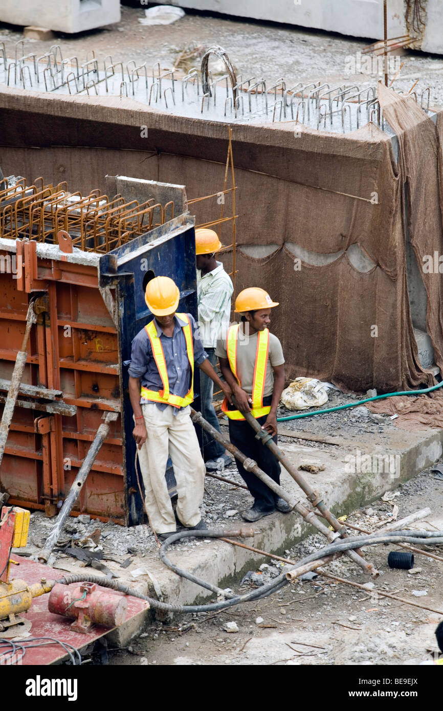 Workers on a construction site building an extension to the city's ...