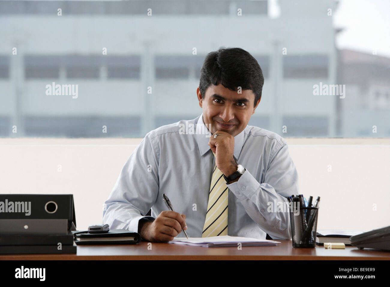 business man writing at his desk Stock Photo - Alamy