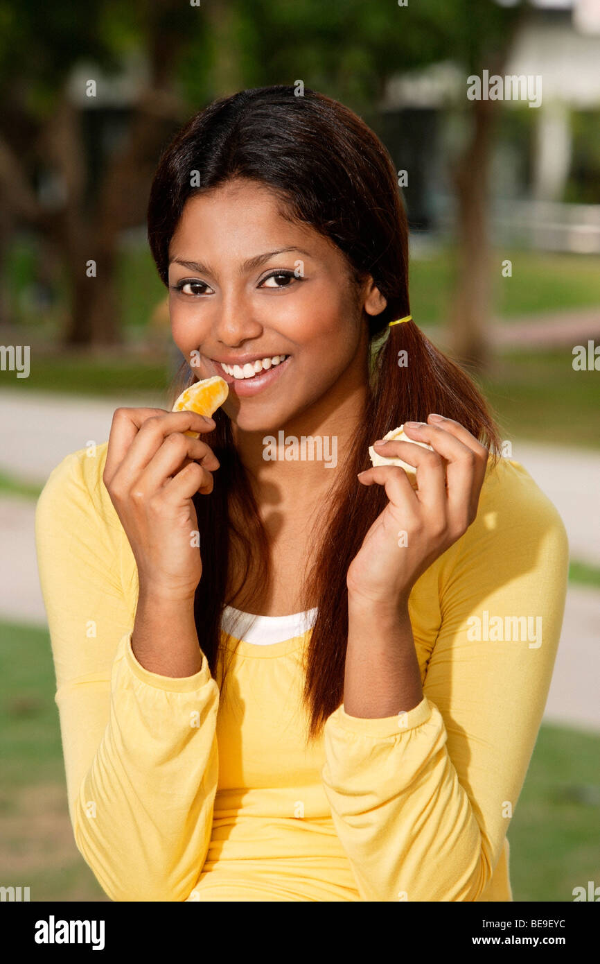 woman eating orange outside Stock Photo - Alamy