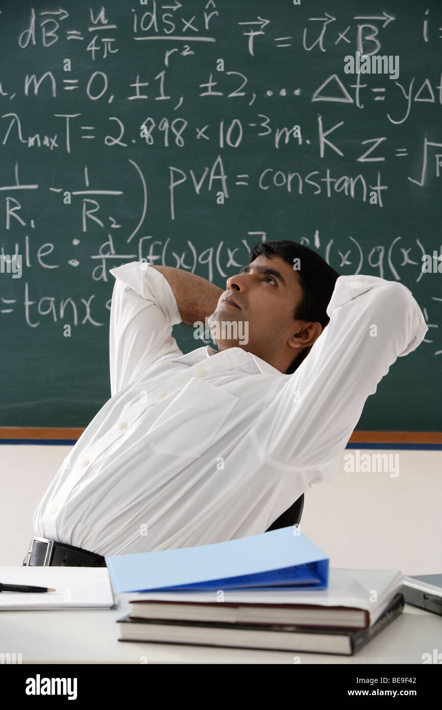 teacher leaning back in his chair Stock Photo - Alamy