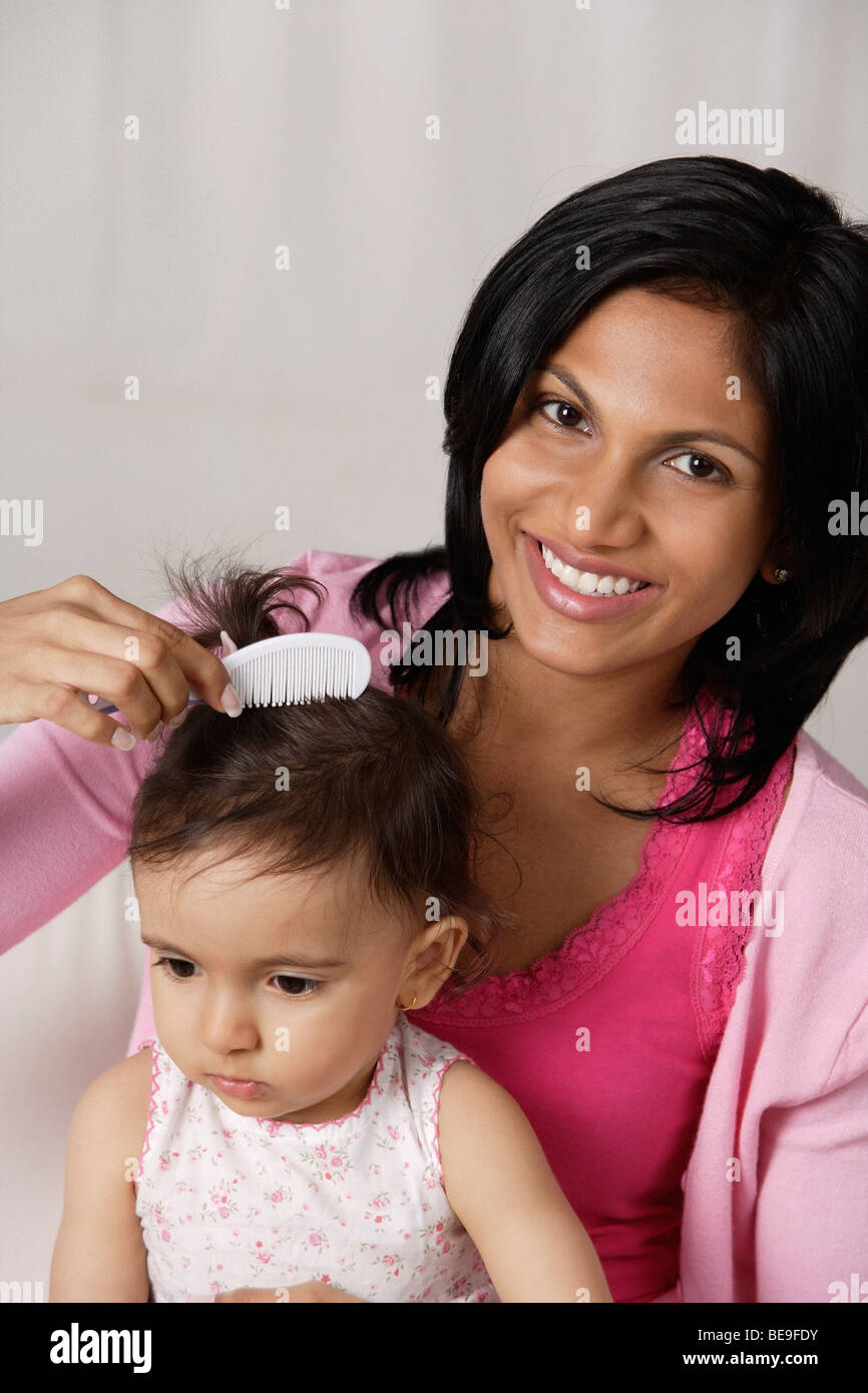 woman combing baby's hair Stock Photo - Alamy