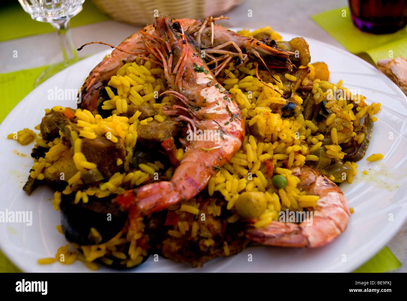 Large white plate piled high with traditional Spanish paella, large ...