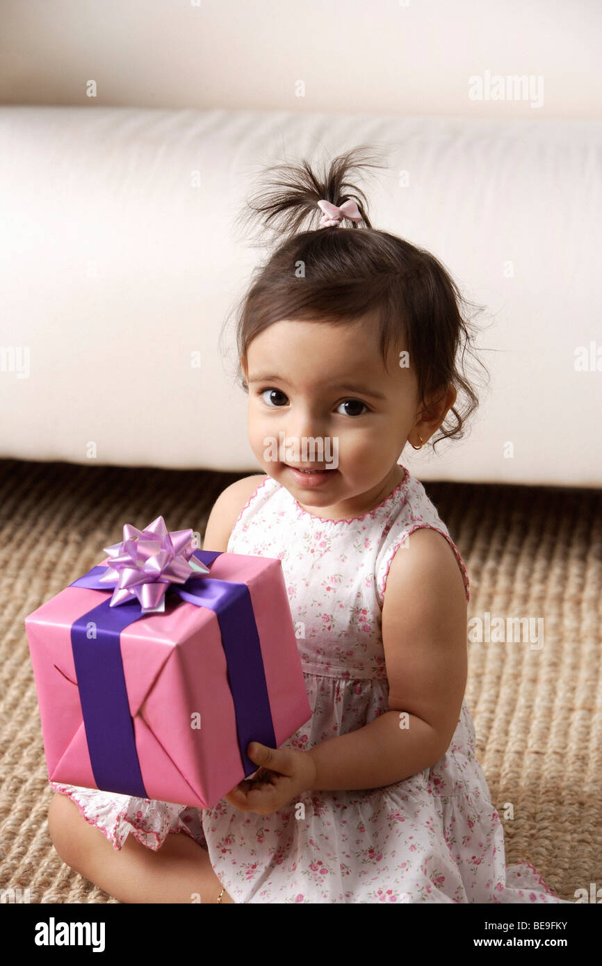 toddler holding a present Stock Photo - Alamy
