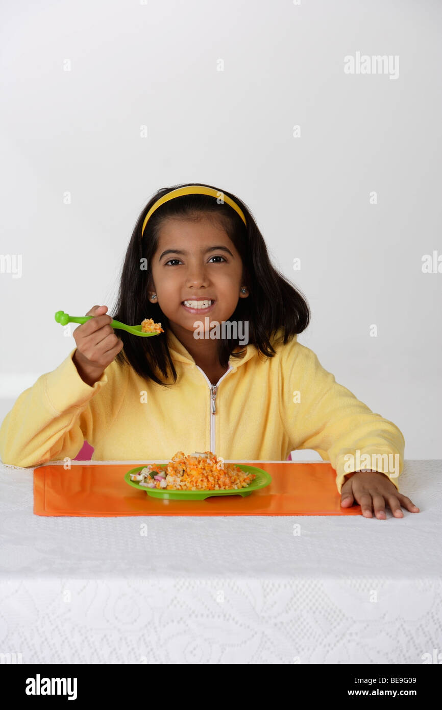 Indian girl eating rice hi-res stock photography and images - Alamy