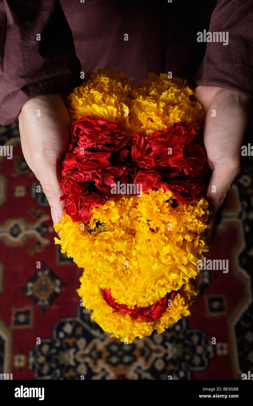 Hands holding flower garlands Stock Photo - Alamy