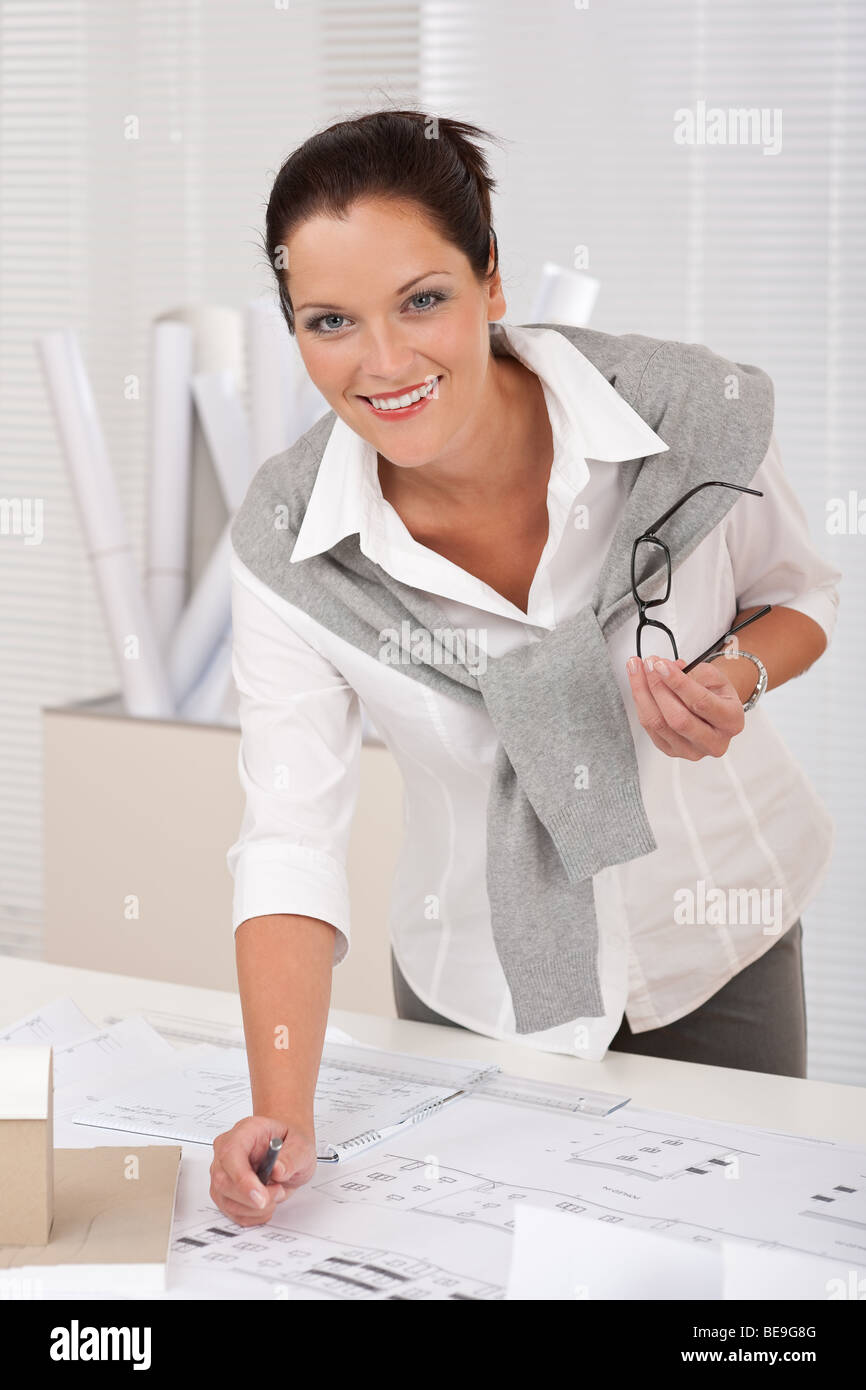 Successful architect woman watching plans at the office Stock Photo - Alamy