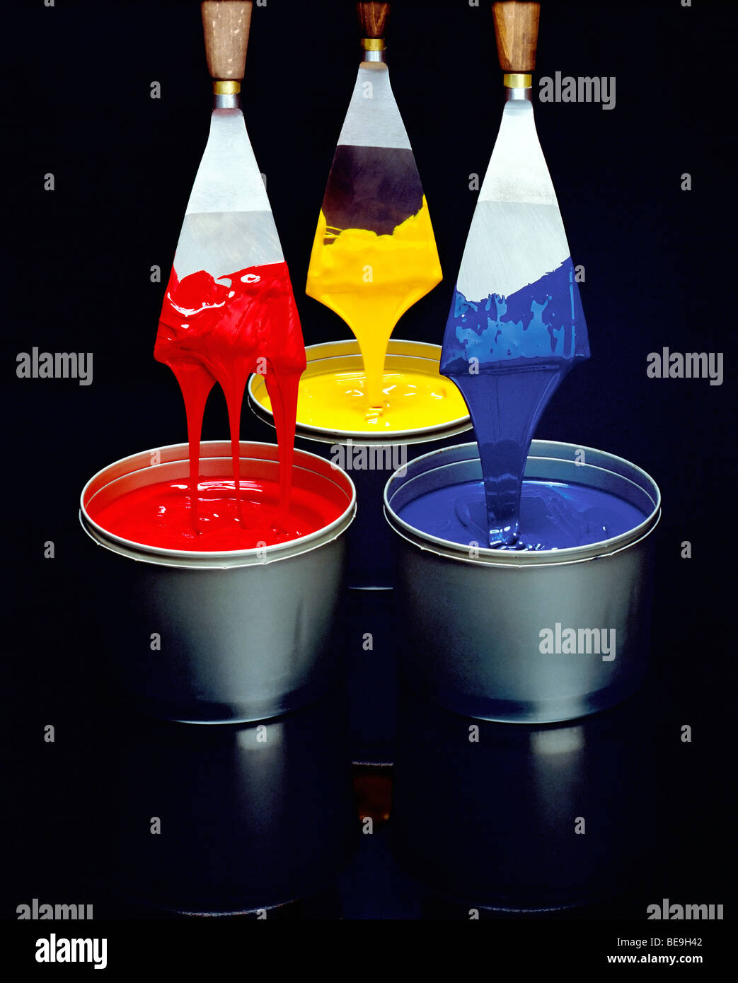 Printing ink cans with spatulas Stock Photo - Alamy
