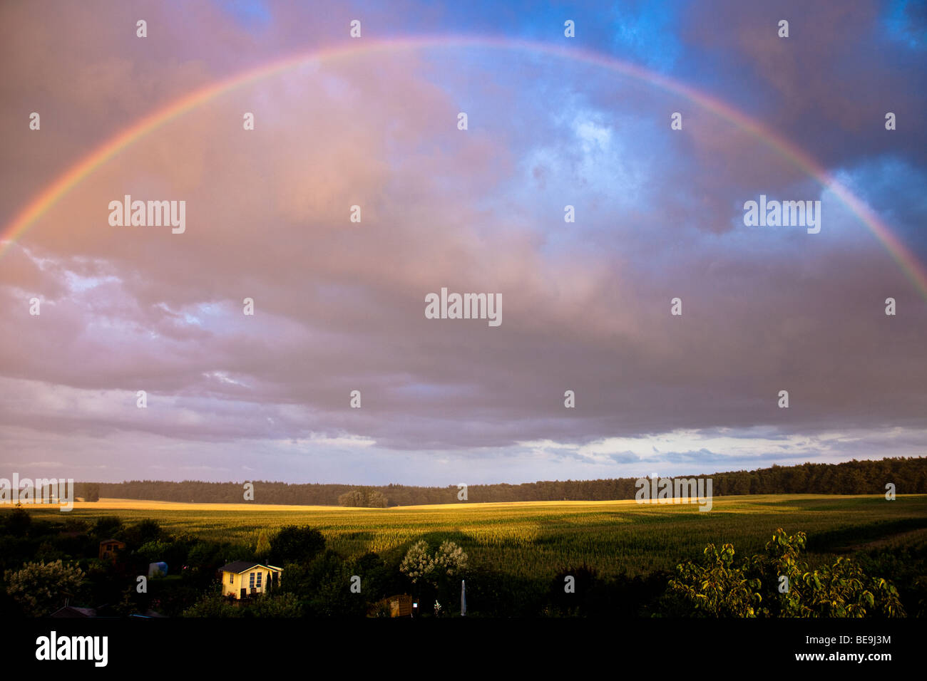 Rainbow in front of a dramatic sky Stock Photo - Alamy