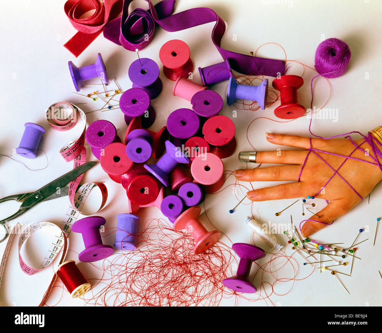 Woman's hand with sewing thread reels Stock Photo - Alamy