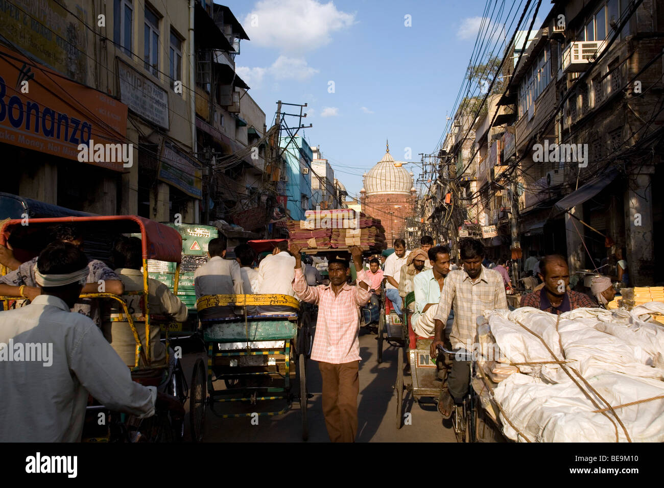 A man struggles through the congested streets of Old Delhi with a heavy ...