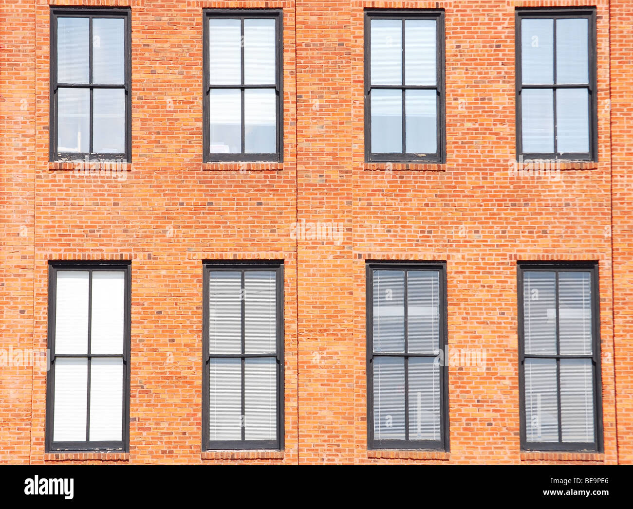 Two rows of windows on a brick building Stock Photo - Alamy