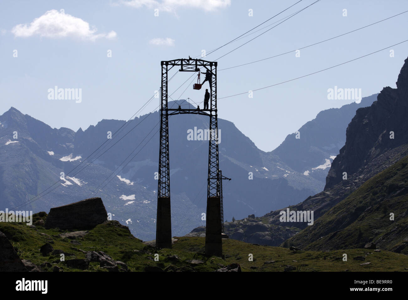 Men working on a pylon, Italy Stock Photo - Alamy