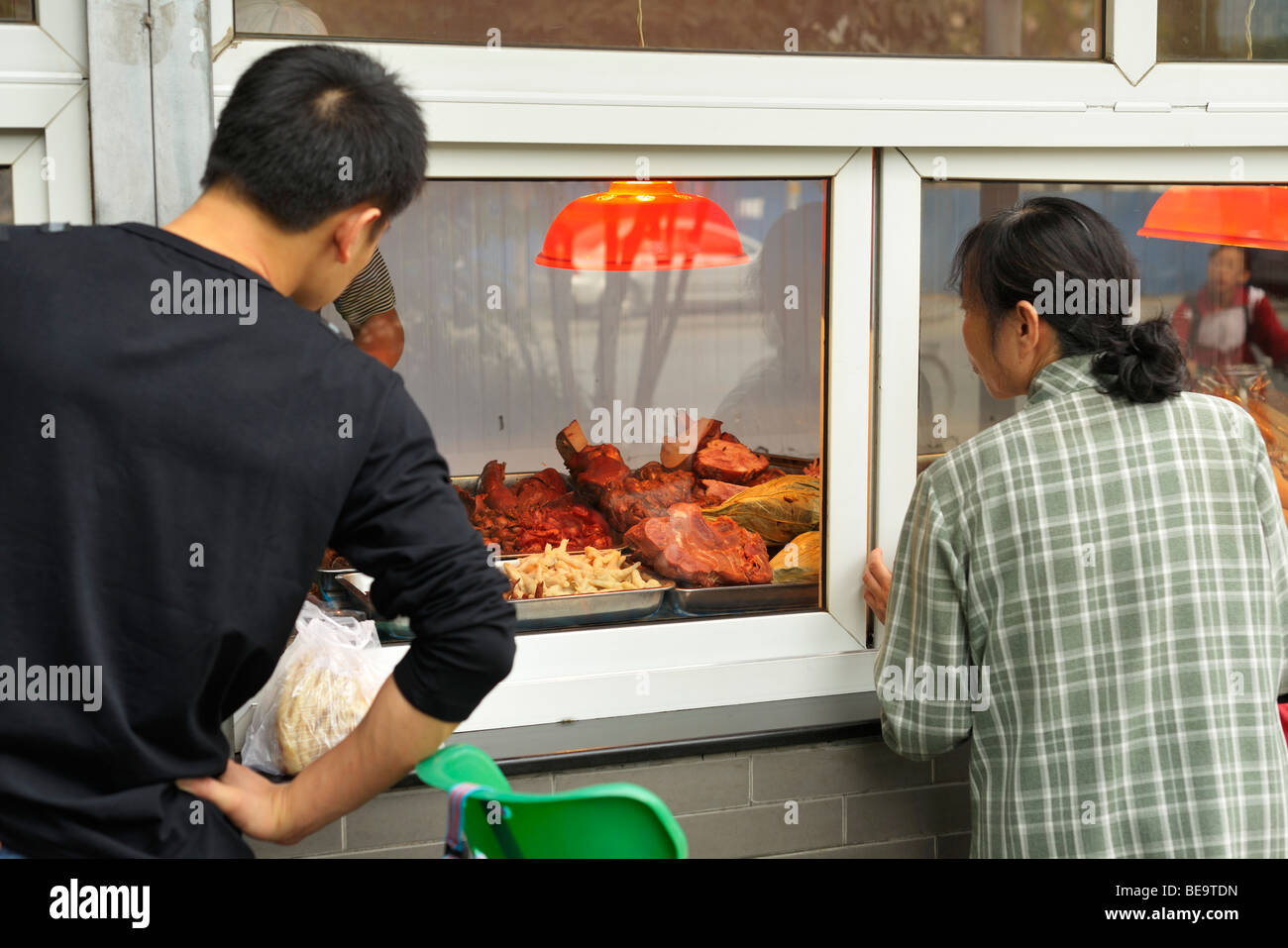 Customers in front of a meat shop, Beijing, China Stock Photo - Alamy