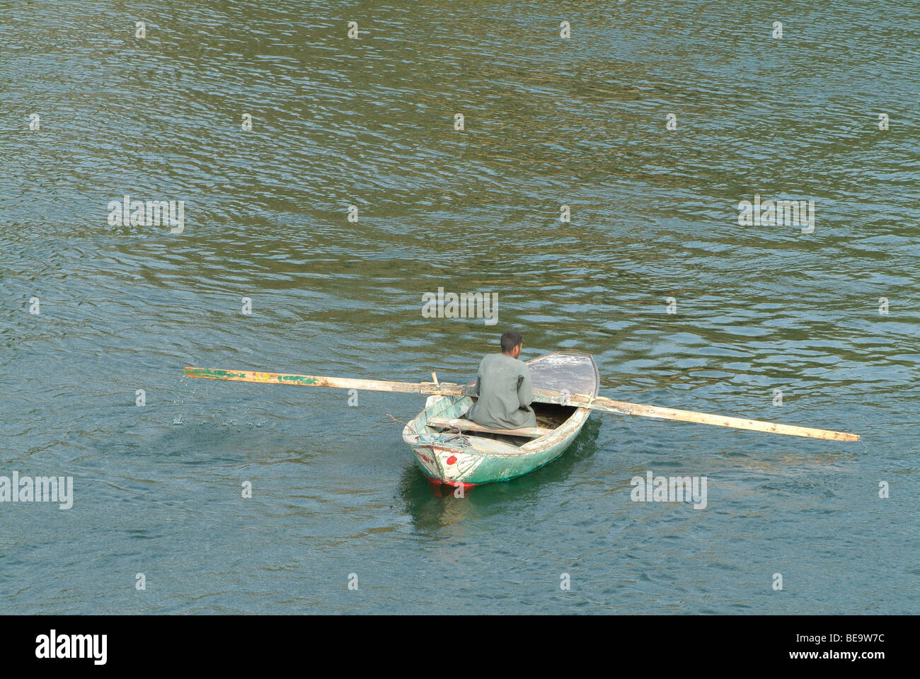 Egyptian man rowing aboard a small wood boat on the Nile river Stock ...
