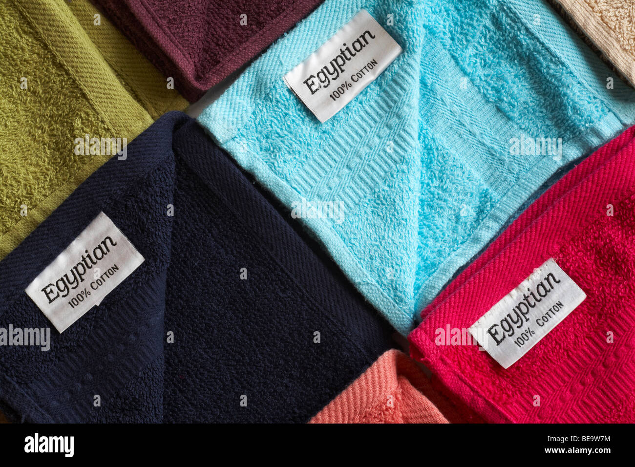 folded flannels of different colours with Egyptian 100% cotton labels ...