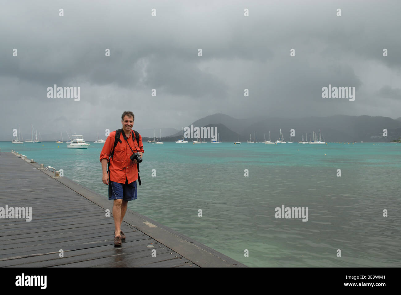 Man walking on a pier, Bay of Sainte Anne, Martinique Stock Photo - Alamy