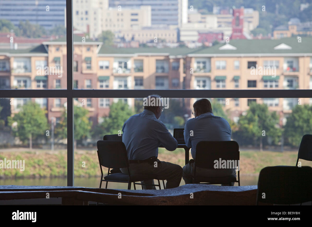 Pittsburgh, Pennsylvania - Two men huddle over a laptop computer in the ...