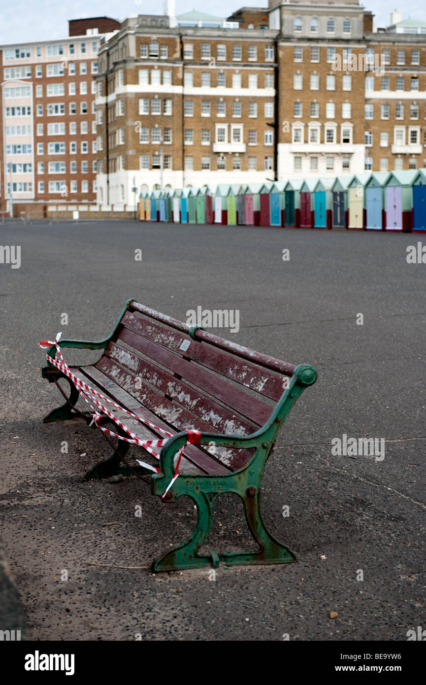 Public seat on a promenade with beach huts Stock Photo - Alamy