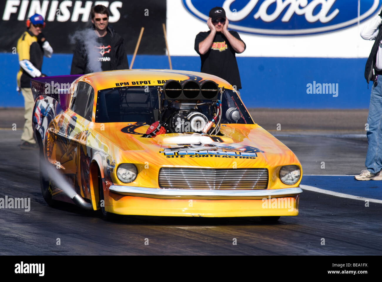A Ford Mustang dragster starts from the line at an NHRA Division 7 ...