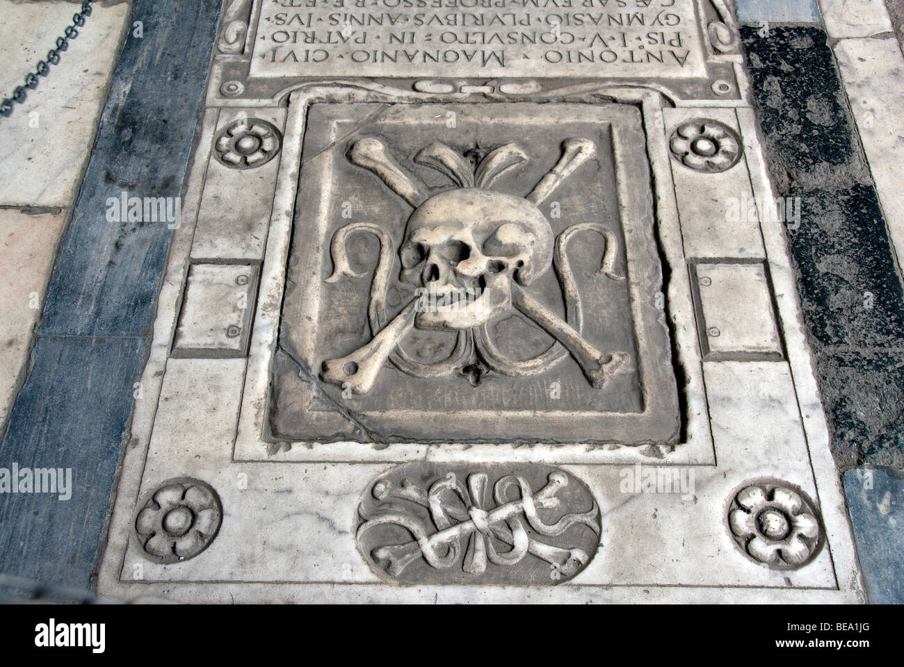 Skull and crossbones marble tomb cover in the Campo Santo Monumentale ...