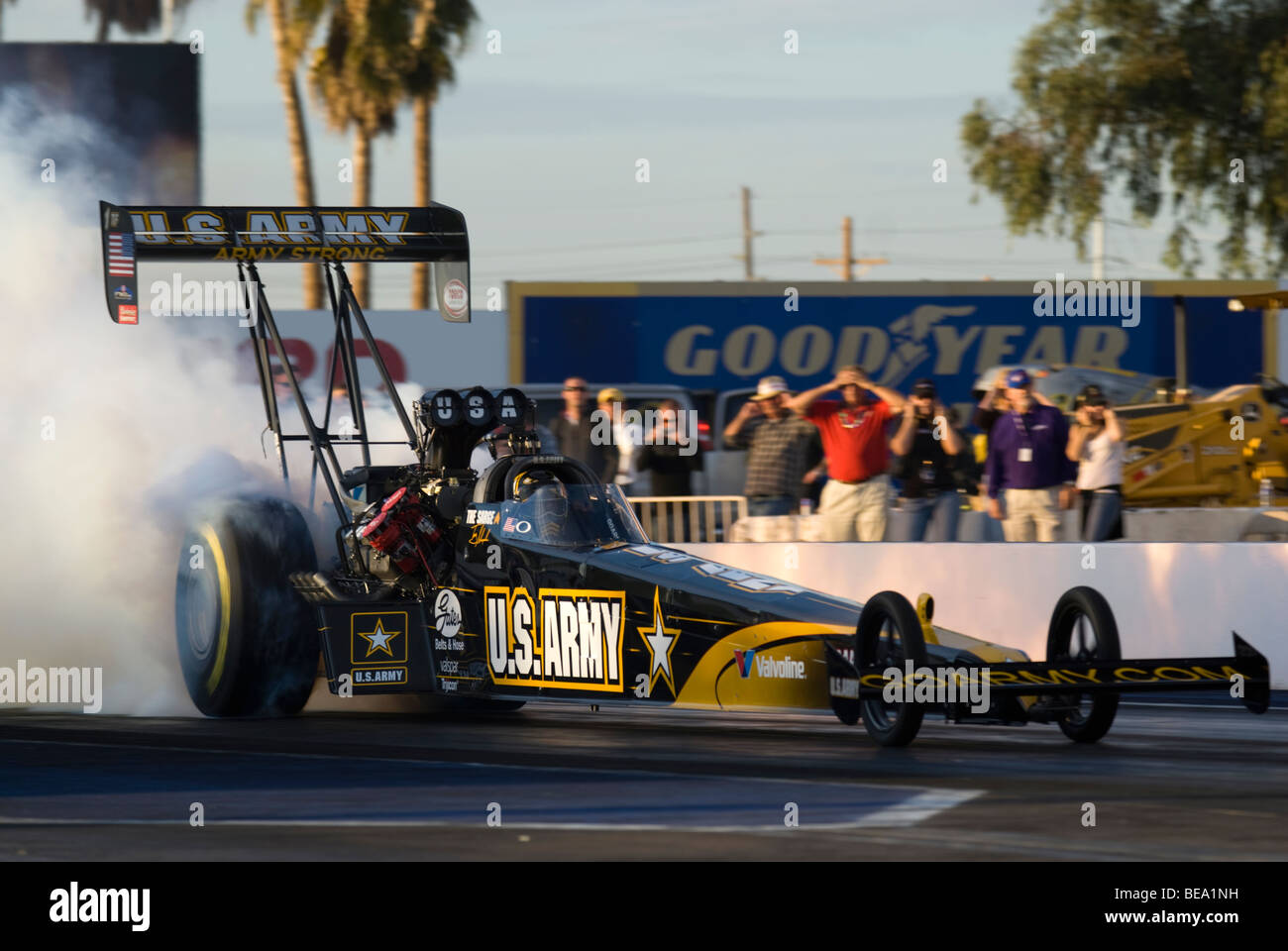 Tony Schumacher burns his tires at the line at the NHRA National Time ...