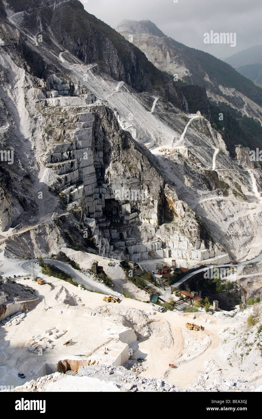 The winding white roads of the marble extraction trucks in the quarry ...