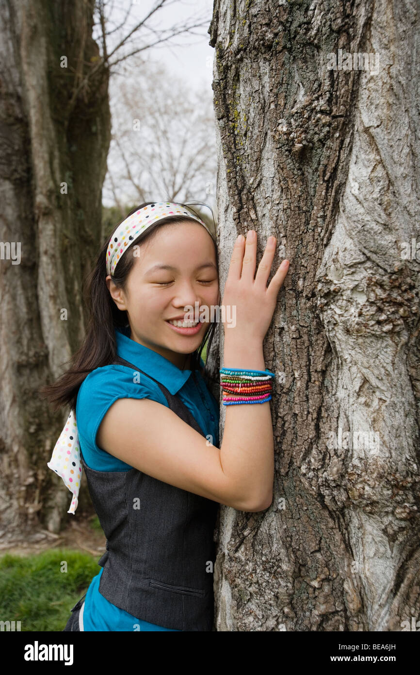 Chinese girl hugging tree Stock Photo - Alamy